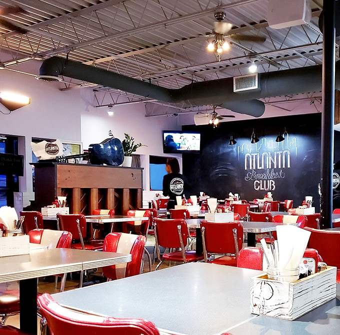 Red chairs and chalkboard walls create that perfect diner-meets-modern vibe where comfort meets cool without trying too hard.