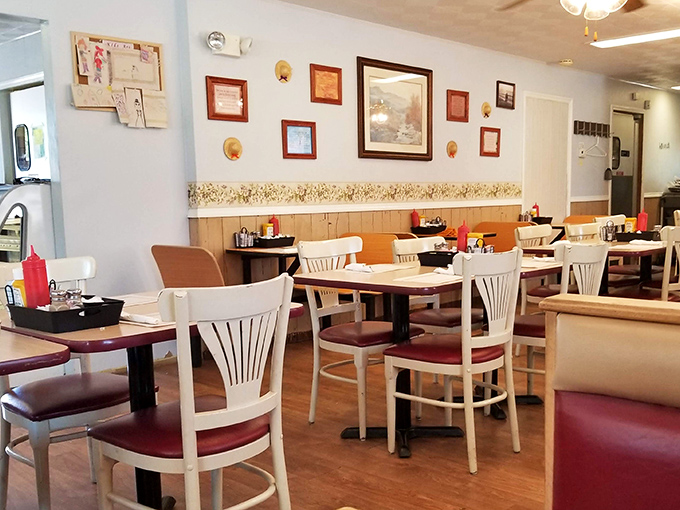 Simple white chairs, warm wood tones, and framed memories on the wall—this isn't Instagram-bait decor, it's the real deal of heartland hospitality.