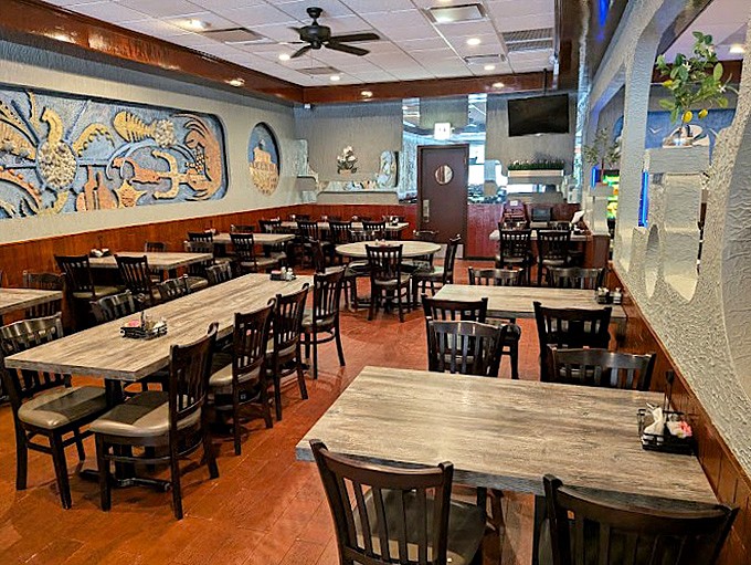 Step into this warm dining room where Greek murals transport you straight to the Aegean without the jet lag.