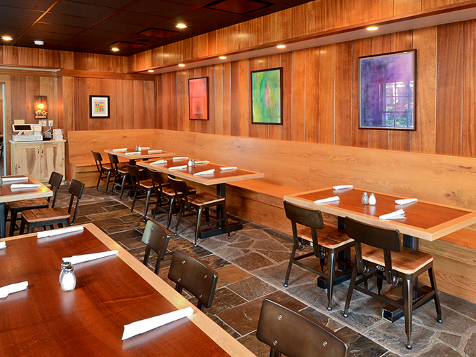 Warm yellow walls, pendant lighting, and tasteful artwork create the perfect backdrop for the flavor explosion that's about to happen on your plate.