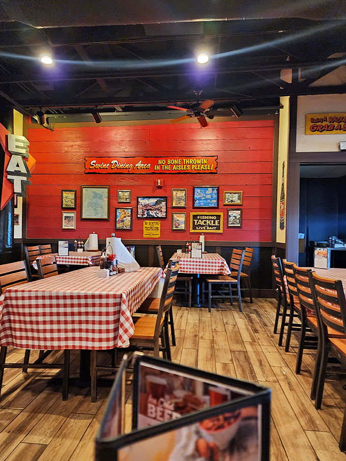 Red walls adorned with fishing memorabilia and that cheeky "No Bone Throwin'" sign create the perfect backdrop for serious meat consumption.