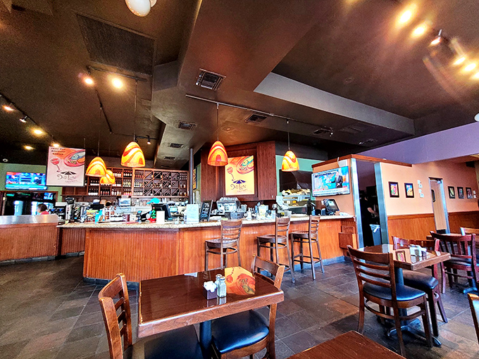 Inside, warm wood tones and colorful pendant lights create the perfect backdrop for both serious eating and not-so-serious conversation.