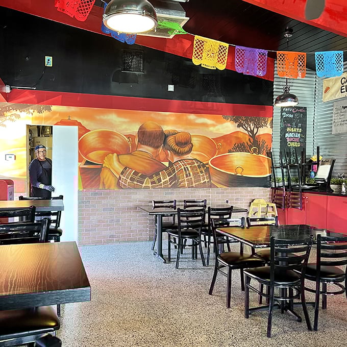 Colorful papel picado banners dance overhead while the mural tells the story of tradition. This isn't d&eacute;cor&mdash;it's a family history painted in copper and flame.