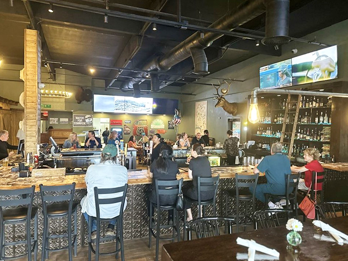 Inside, rustic meets modern with exposed ductwork, warm wood accents, and a bustling bar that invites you to pull up a stool and stay awhile.