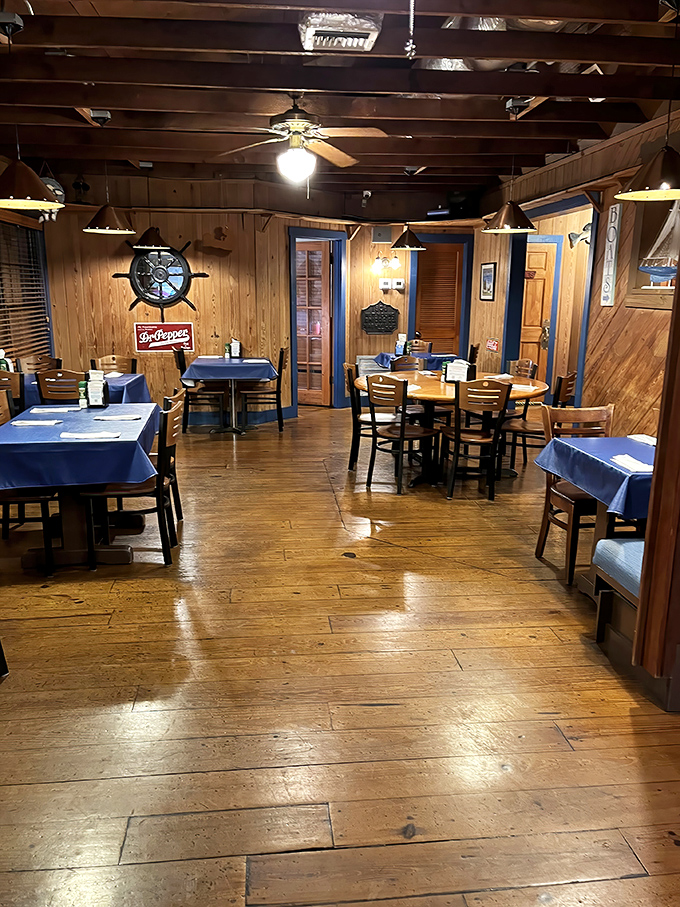 Classic diner geometry: red vinyl chairs + checkered accents + orange pendant lights = the universal equation for comfort food happiness.