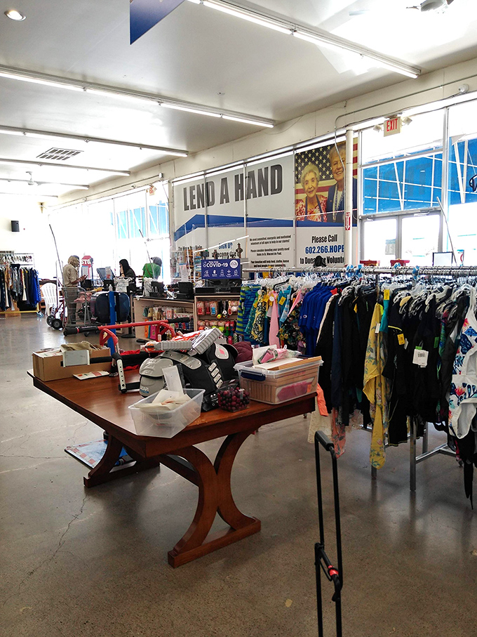 Racks of possibility stretch across the concrete floor. That "Lend a Hand" banner isn't just decoration—it's the store's entire philosophy in action.
