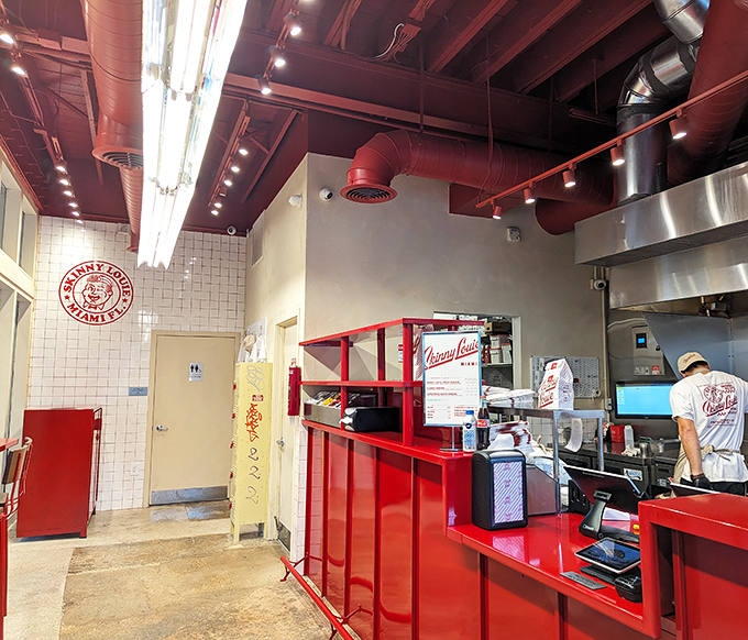 Industrial-chic meets burger paradise with those signature red pipes overhead&mdash;proof that great design and greater food can coexist beautifully.