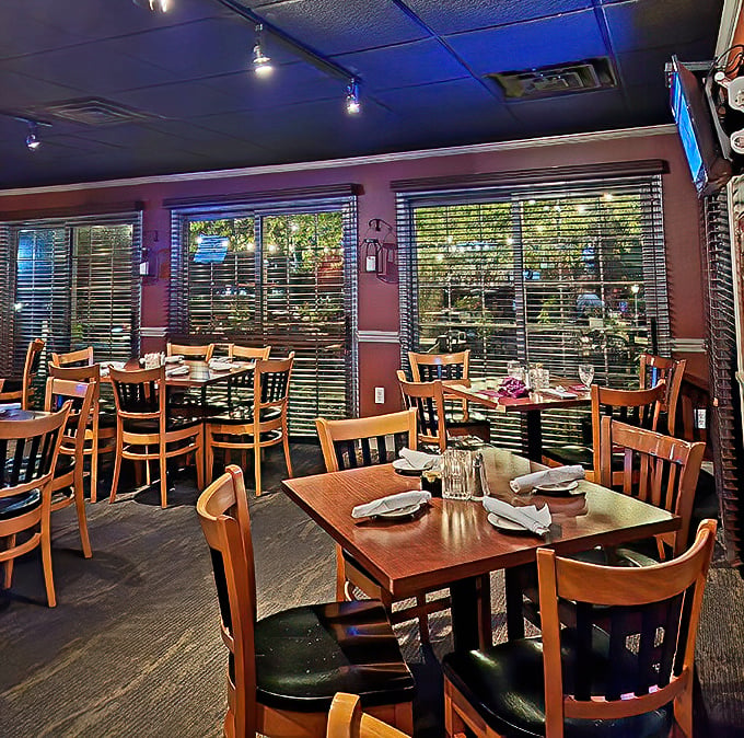 Warm wooden tables and burgundy walls create the perfect backdrop for memorable meals. This isn't just dining&mdash;it's a cozy retreat from the outside world.