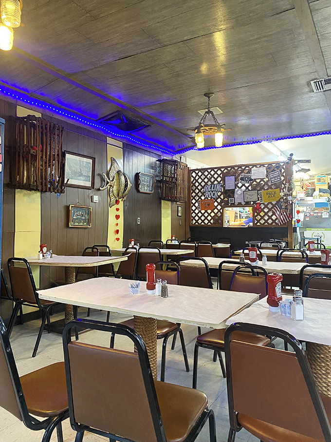 Blue lights and wood paneling create that "you're not in Kansas anymore" vibe&mdash;a dining room that feels like you've stepped into a beloved captain's quarters.
