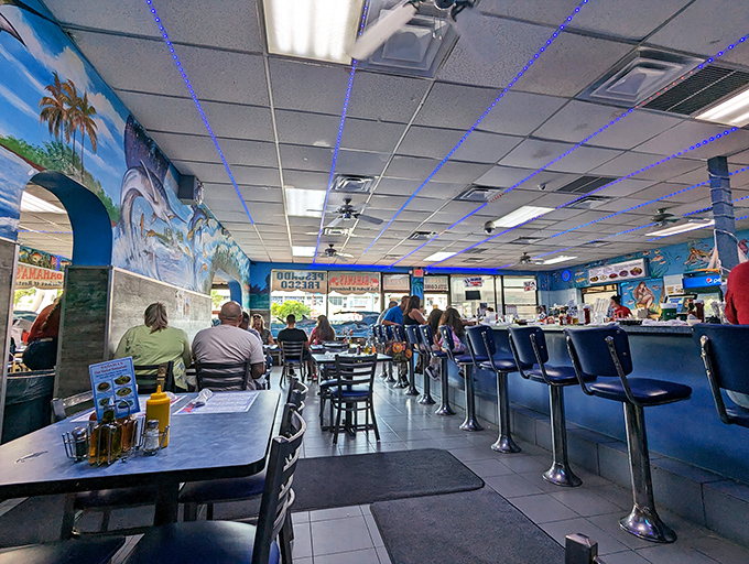 Blue walls, ocean murals, and counter seating create the perfect backdrop for seafood conversations that inevitably begin with "You've got to try the..."