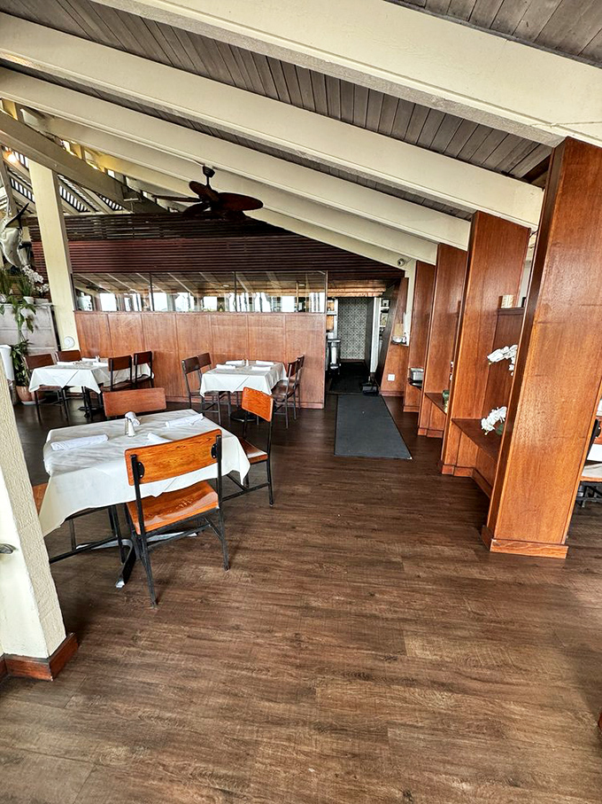 Warm wood paneling and crisp white tablecloths create that perfect sweet spot between "fancy enough for an anniversary" and "casual enough for Tuesday lunch."