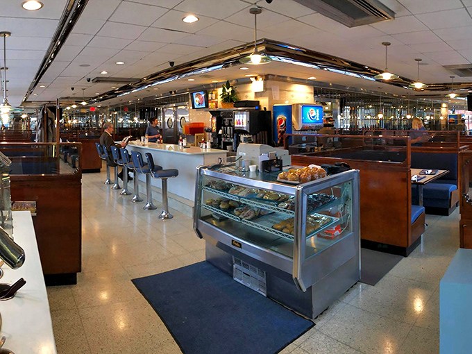 Inside, the gleaming counter and cozy booths invite you to slide in and stay awhile. The dessert case's silent siren song is already working its magic.