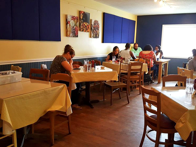 Inside, yellow walls and blue accents create that perfect small-town cafe vibe where conversations flow as freely as the coffee.