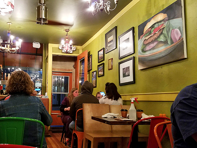 Step inside and the mustard-yellow walls, vintage chandeliers, and burger artwork immediately signal you've found a place that takes comfort food seriously.