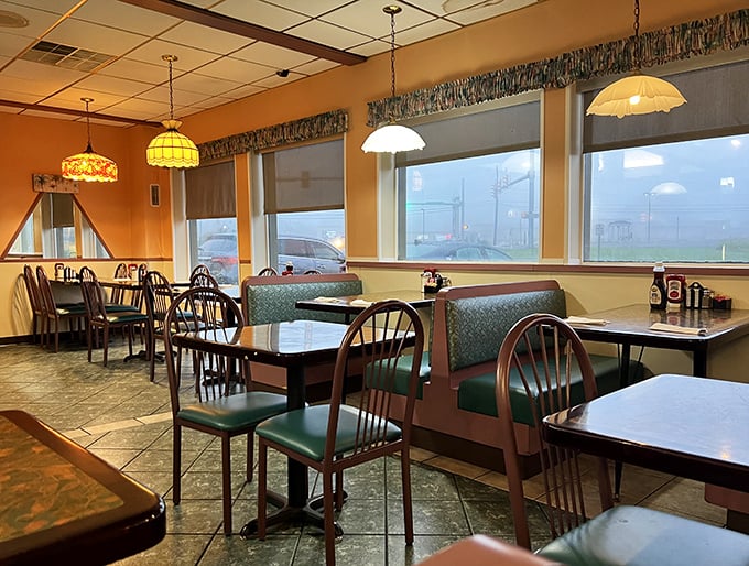 Tiffany-style pendant lamps cast a warm glow over teal vinyl booths, creating that perfect "I've come home" feeling every great diner should deliver.