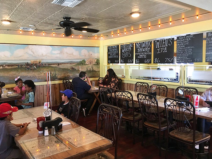 Inside Joey's, string lights cast a warm glow over wooden tables while a pastoral mural reminds you that great barbecue is rooted in tradition, not trends.