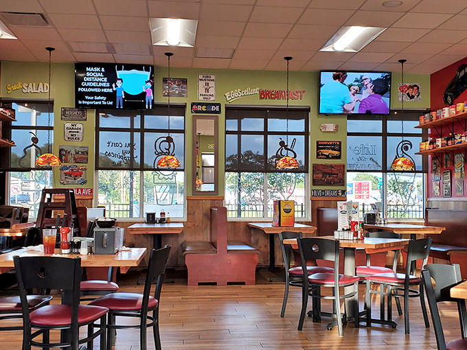 Inside Angelo's, where the pressed tin ceiling watches over pizza artistry and the wall of memorabilia tells stories of Philly pride.