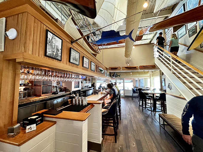 Nautical elegance meets casual comfort inside, where wooden beams, model ships, and that Florida sunshine create the perfect seafood sanctuary.