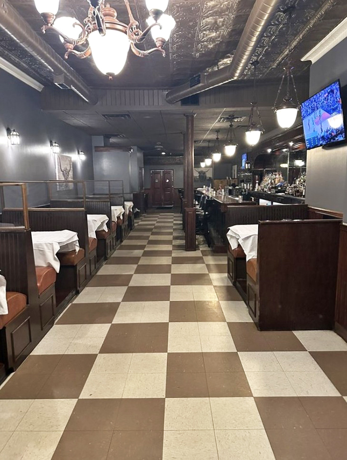 Classic checkered floors and warm lighting create that "where everybody knows your name" vibe. The tin ceiling adds vintage charm that whispers, "Stay awhile."