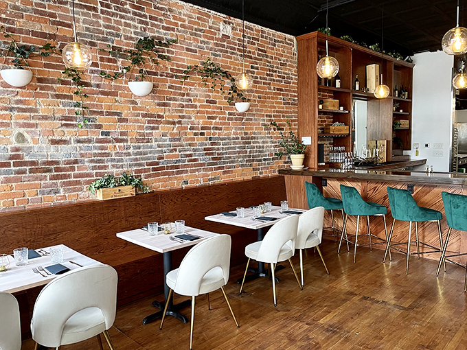 Exposed brick walls meet modern design elements in this cozy dining space where every seat feels like the best one in the house.