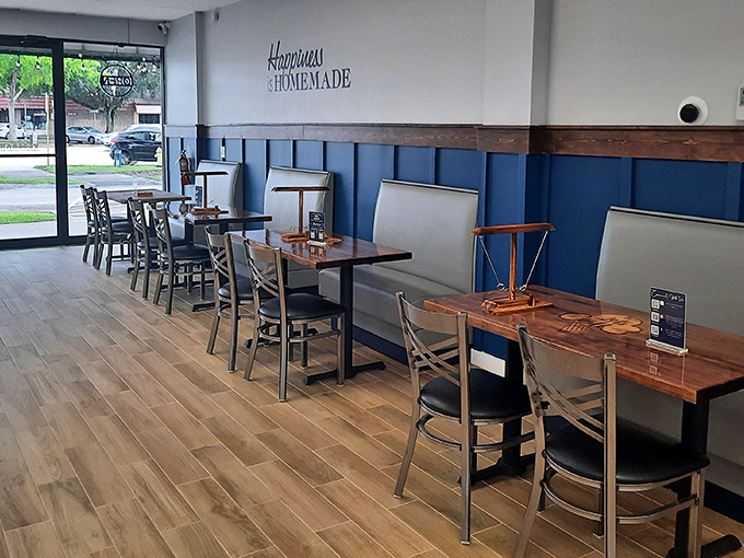 Clean lines, blue wainscoting, and wooden tables create a coastal-meets-homey vibe that's as refreshing as the treats they serve.