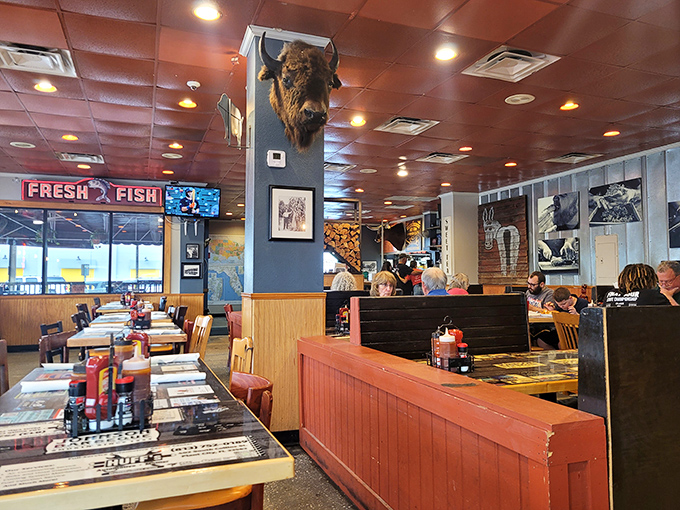 A buffalo head watches over diners like a stoic guardian of smoke and flavor. The wood-paneled interior feels like stepping into a time capsule of authentic Florida BBQ tradition.