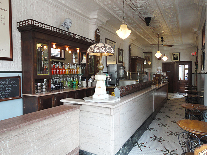 The gleaming marble counter and ornate tin ceiling aren't movie props&mdash;they're the real deal. This narrow space somehow holds a century of soda fountain history.