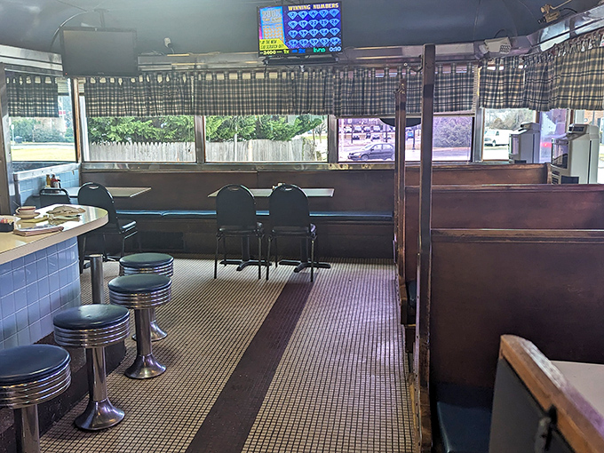 Chrome stools await their next storytellers while checkered curtains filter the morning light&mdash;this isn't d&eacute;cor, it's diner DNA in its purest form.