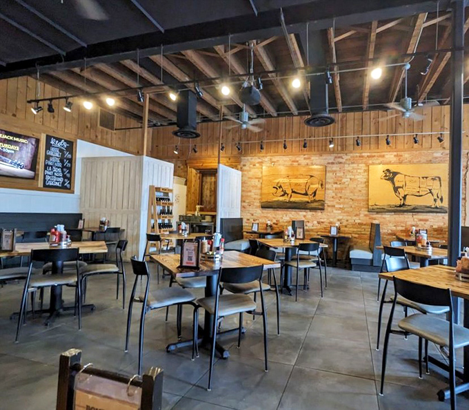 Rustic meets refined inside with exposed beams, brick walls, and whimsical pig artwork&mdash;a temple where barbecue is taken seriously without taking itself too seriously.