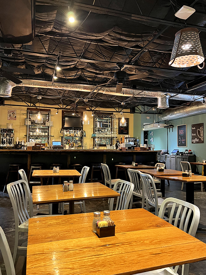 Industrial meets cozy in this dining room where wooden tables and metal chairs create the perfect backdrop for morning conversations and coffee refills.