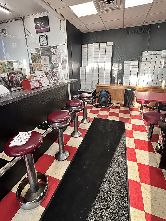 Classic diner stools and checkered floors create the perfect backdrop for serious donut contemplation sessions.