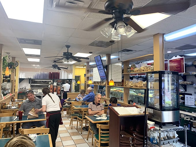 The bustling interior hums with conversation and clinking plates, a symphony of satisfaction orchestrated beneath lazily spinning ceiling fans.