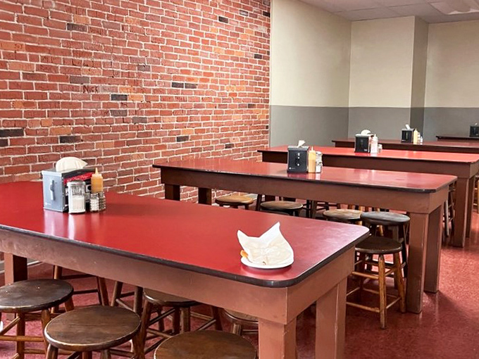 Those red tables have hosted more conversations than a therapist's couch &ndash; and they're way cheaper.