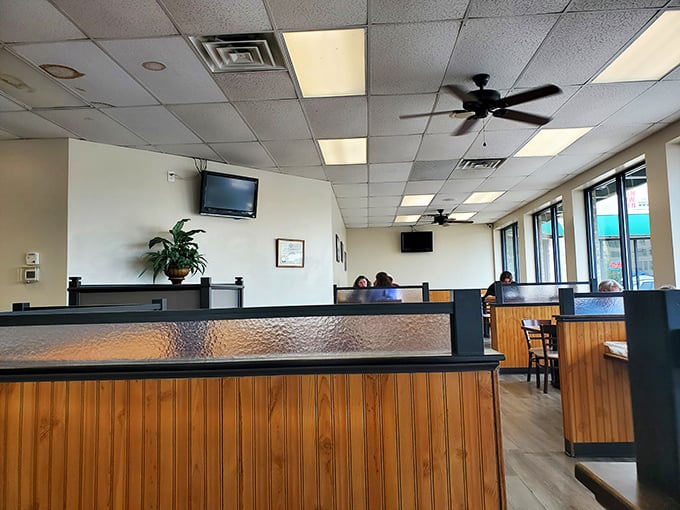 Classic wooden booths and textured dividers create that nostalgic diner atmosphere where conversations flow as freely as the coffee refills.
