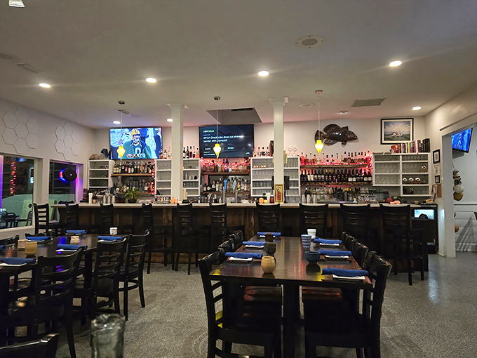 The bar beckons with bottles gleaming like treasure, while blue-topped tables await the parade of Gulf delicacies to come.