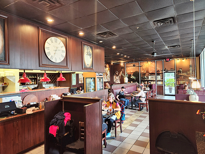 Classic diner ambiance with burgundy booths and checkered floors. Those wall clocks aren't just decoration&mdash;they're counting down to your next meal.