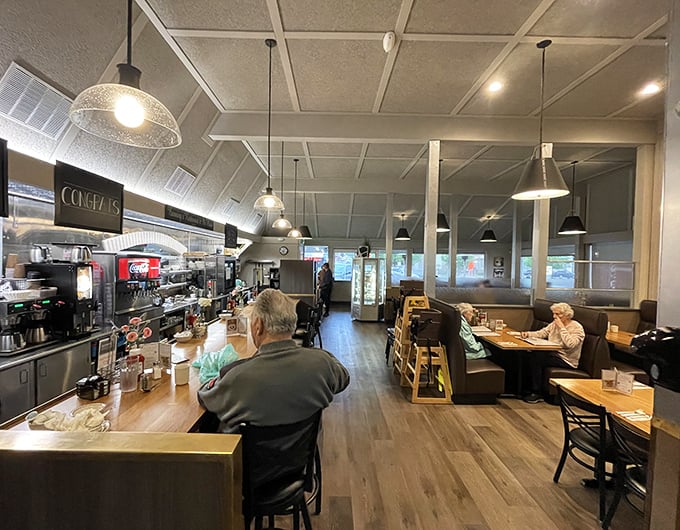 Inside, pendant lights cast a warm glow over wood floors and comfortable seating—the stage is set for comfort food theater.