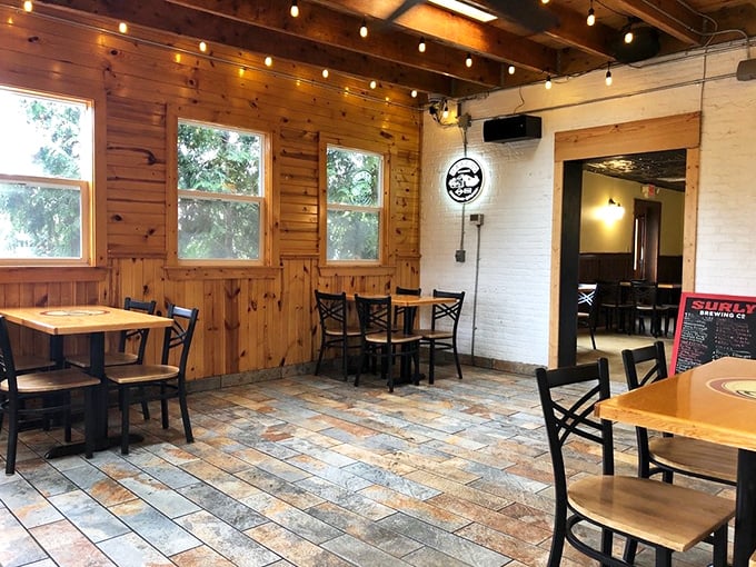 Wooden paneling meets white brick walls in this cozy dining space where string lights cast a warm glow that makes everyone look like they're having the time of their lives.