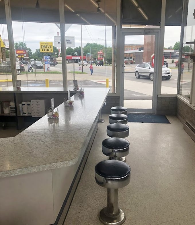 Classic counter seating where strangers become friends over shared sugar highs. These stools have witnessed more morning revelations than most therapists. 