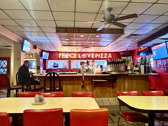 Inside, the "Pizza Capital of the World" sign hangs proudly above a classic interior where time seems to slow down and pizza appreciation speeds up.