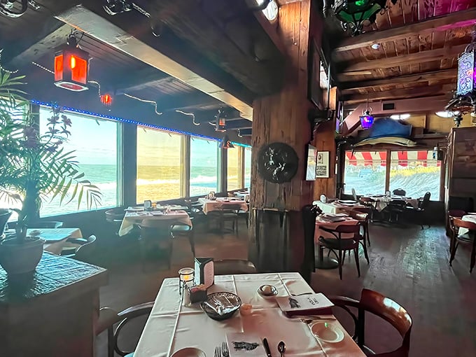 Sunlight streams through floor-to-ceiling windows, turning an ordinary lunch into oceanfront theater where waves crash and seafood shines.