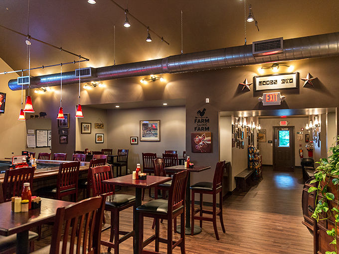 Dark wood tables bathed in warm lighting create that rare atmosphere where conversations flow as smoothly as the BBQ sauce. Rustic elegance without pretension.