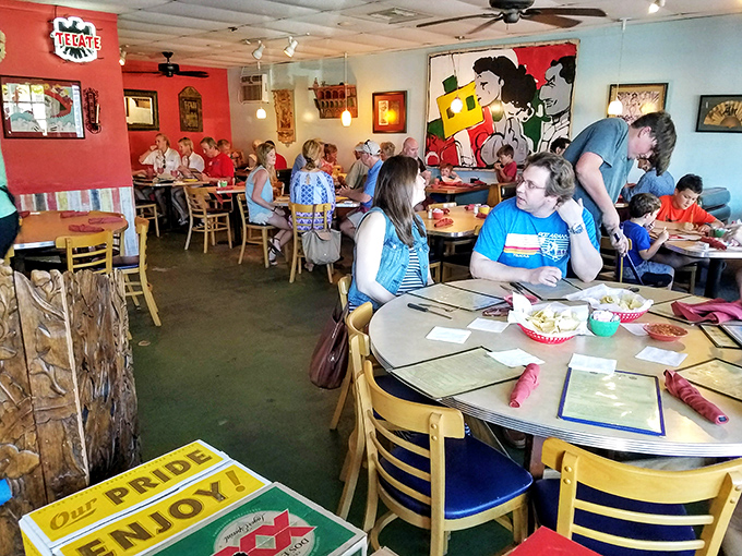 Inside, vibrant walls and authentic Mexican artwork create an atmosphere that instantly transports you south of the border.