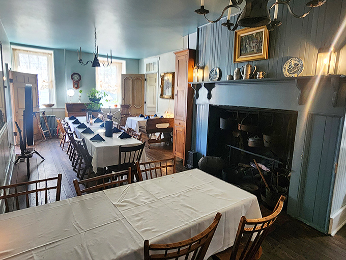 Step back in time where blue-painted walls, colonial furnishings, and a working fireplace create the kind of authentic atmosphere no corporate restaurant chain could ever replicate.