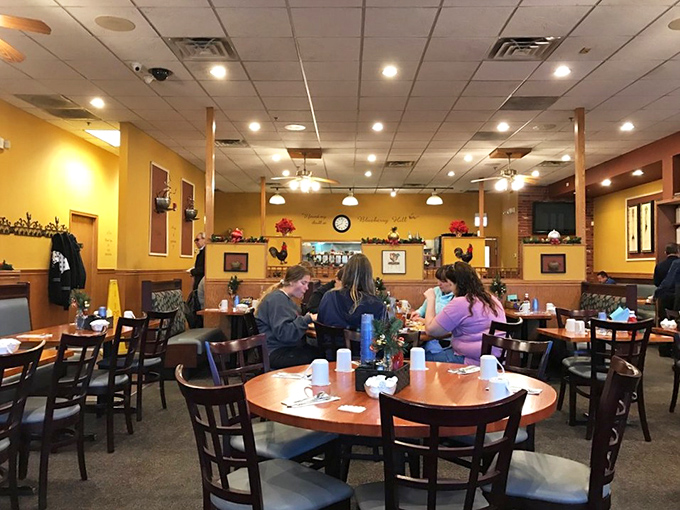 Warm yellow walls and wooden tables create that perfect diner ambiance. The kind of place where coffee refills appear before you even ask.