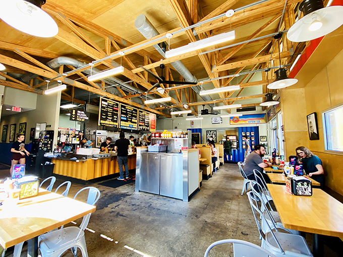 Exposed wooden beams and metal accents create a modern, airy space where burger dreams come true. The line at the counter suggests it's worth the wait.