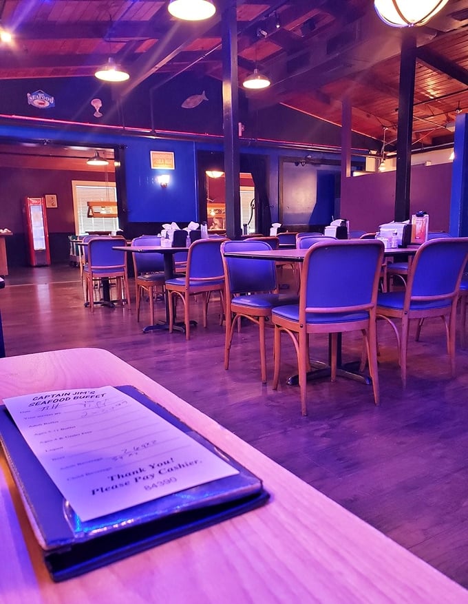 Blue chairs and wooden accents create a casual maritime atmosphere where the only dress code is "hungry." The dining room invites you to settle in for a feast.