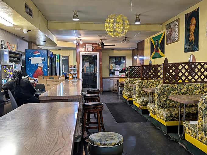 Cozy booths with vintage floral upholstery and Jamaican flags create an unpretentious vibe where the food, not the decor, takes center stage.
