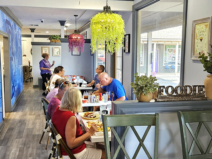 Colorful chandeliers dance overhead while diners dive into morning delights. It's breakfast theater in the round!