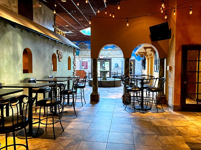 Step inside and you're transported to an Italian village square, where arched doorways and string lights create the perfect backdrop for pasta-fueled romance.